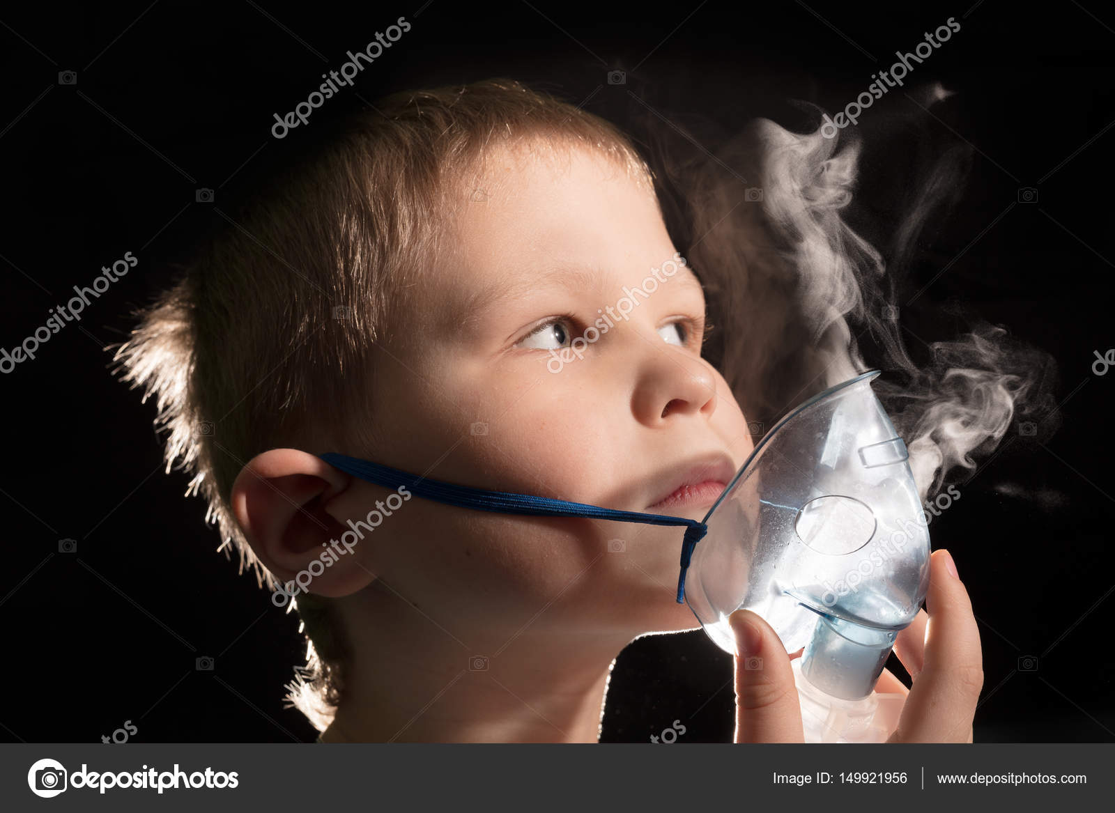 Kid breathing through nebulizer mask Stock Photo by ©IdeaStudios 149921956