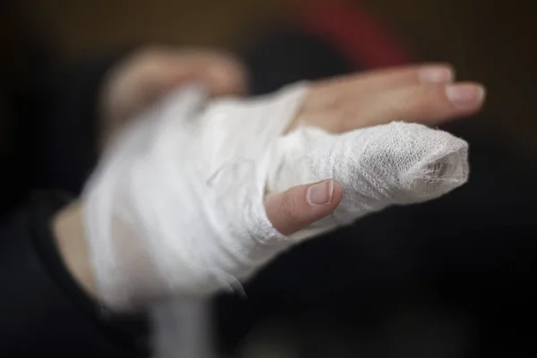 Applying a bandage to a broken finger. Fixing a broken finger for bone ...