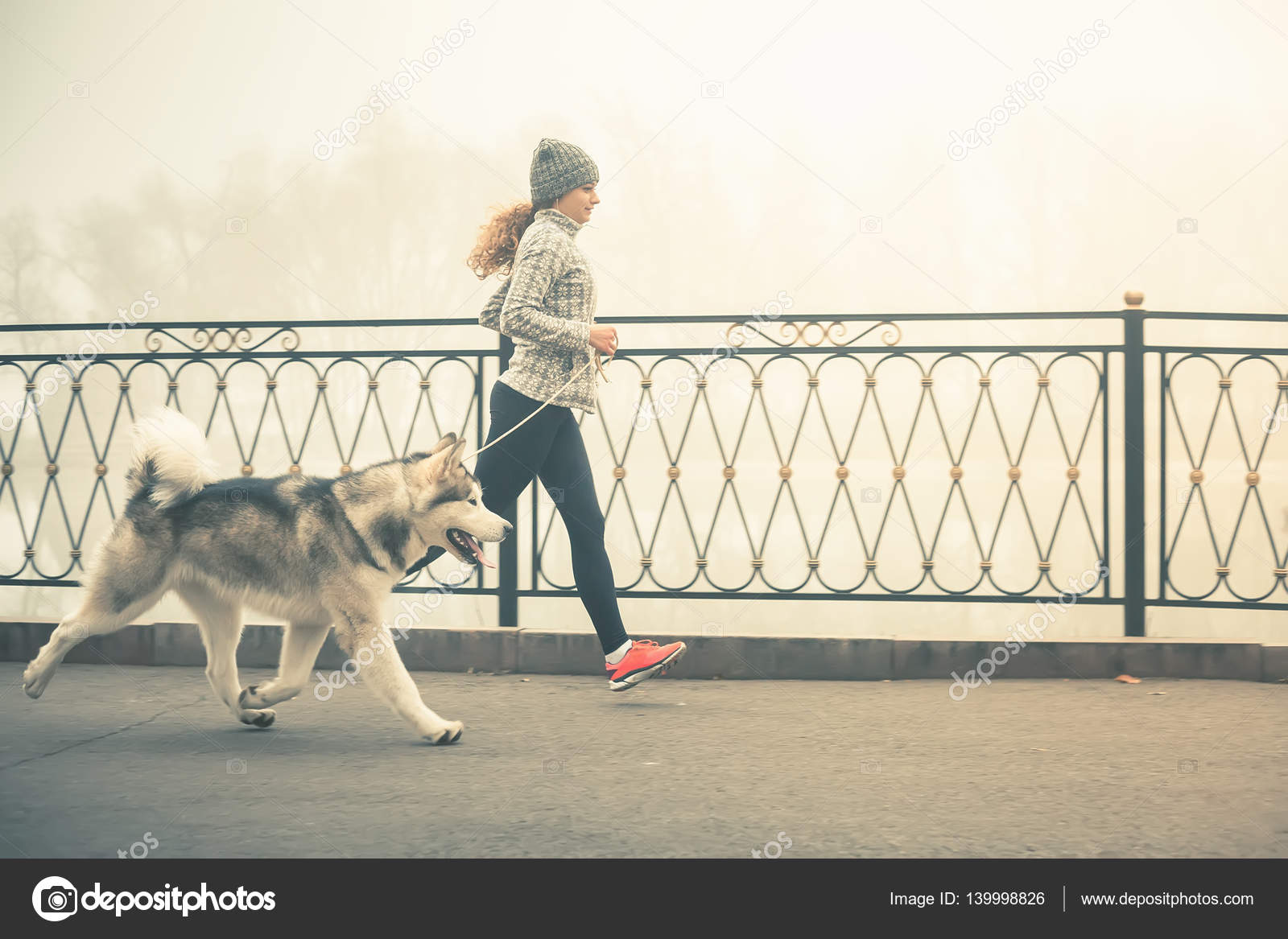 Image of young girl running with her dog, alaskan malamute — Stock ...