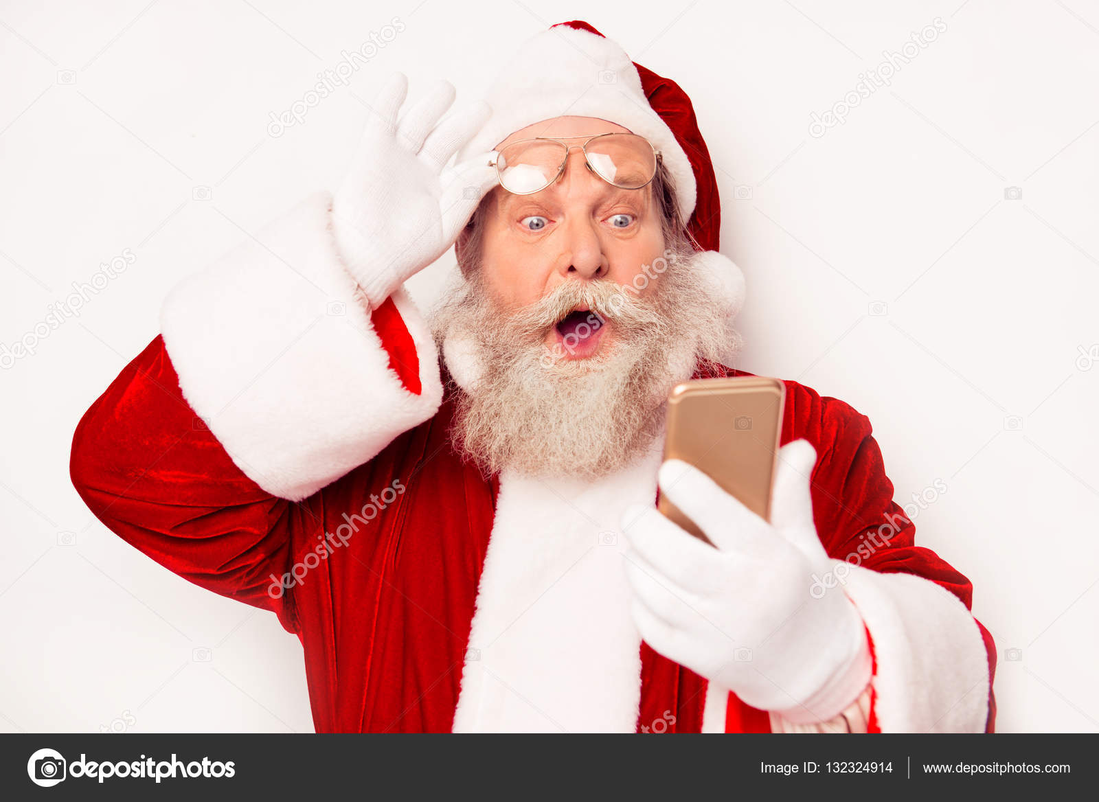 Portrait of excited Santa looking on clock on smartphone and und Stock ...