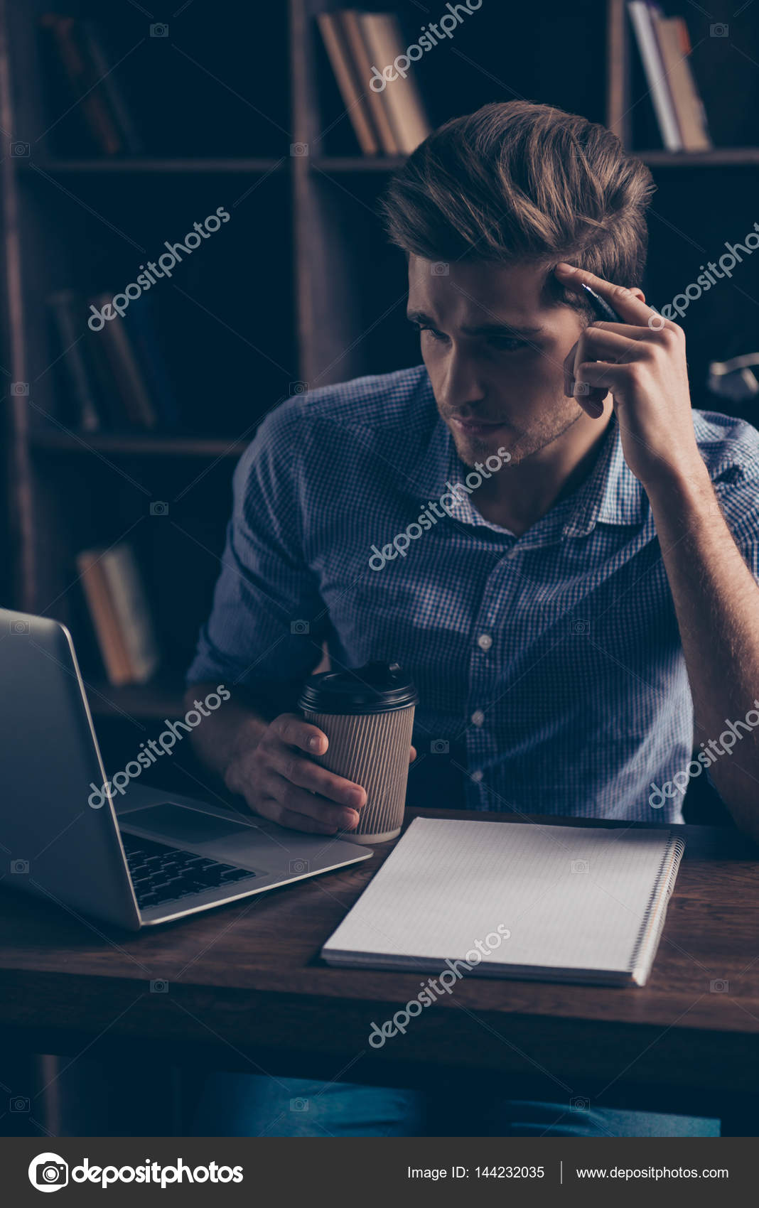 Young tired concentrated man trying to complete hard task Stock Photo ...