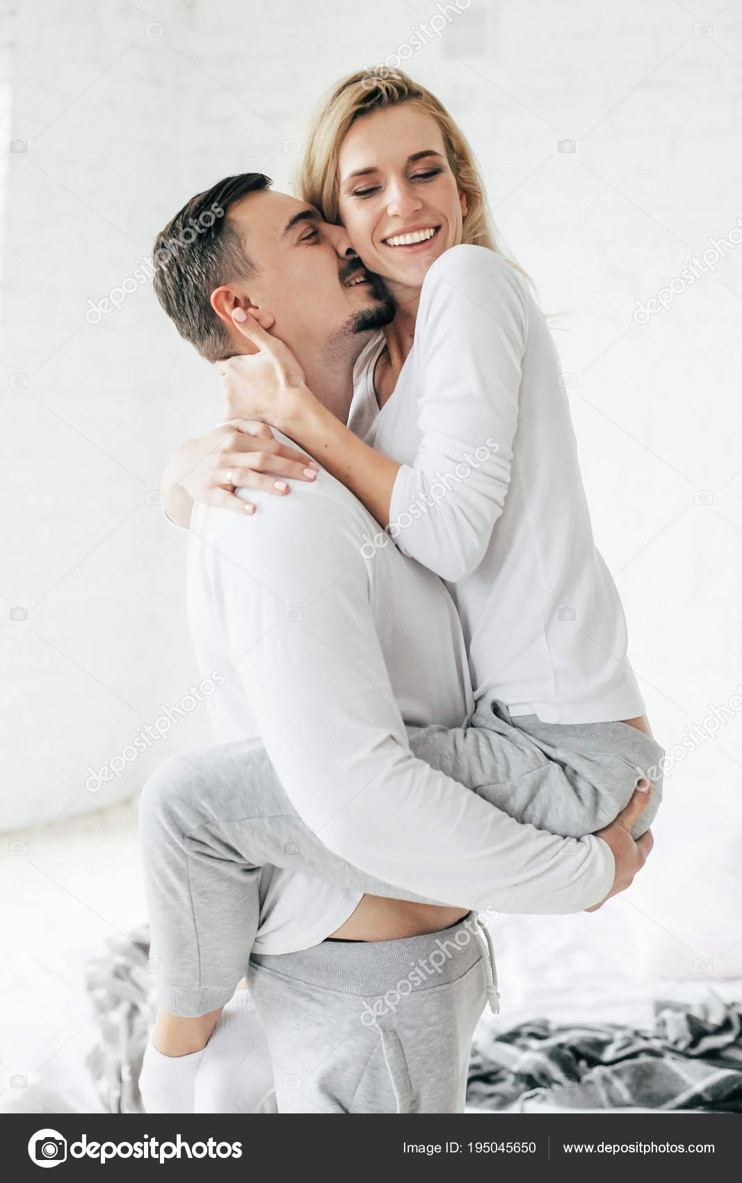 Guy Holding Girl In Arms Kissing