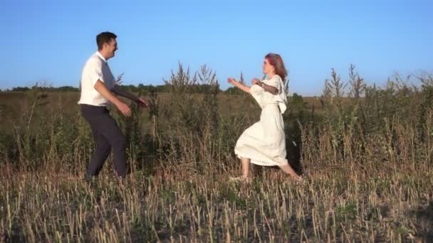 Couple in love are running to each other then hug and spin around ...