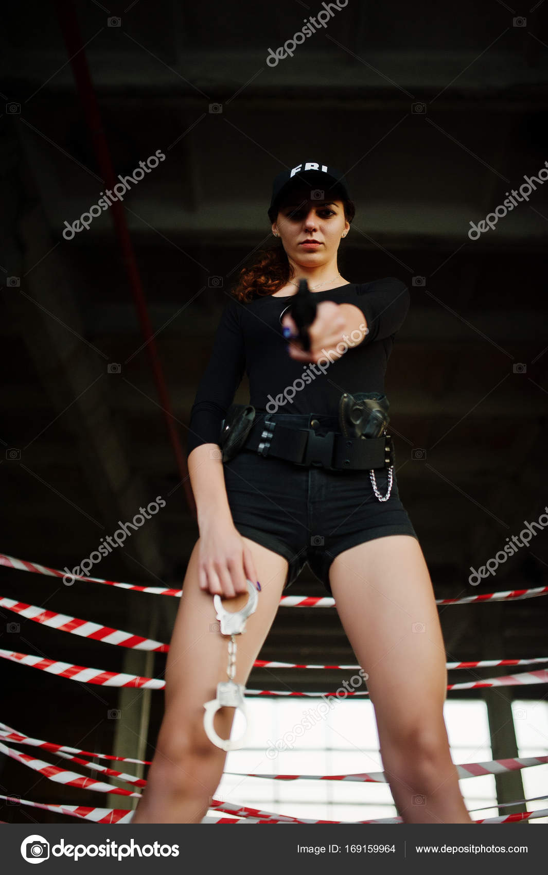 Sexy FBI female agent at abadoned place. — Stock Photo © ASphoto777 #169159964