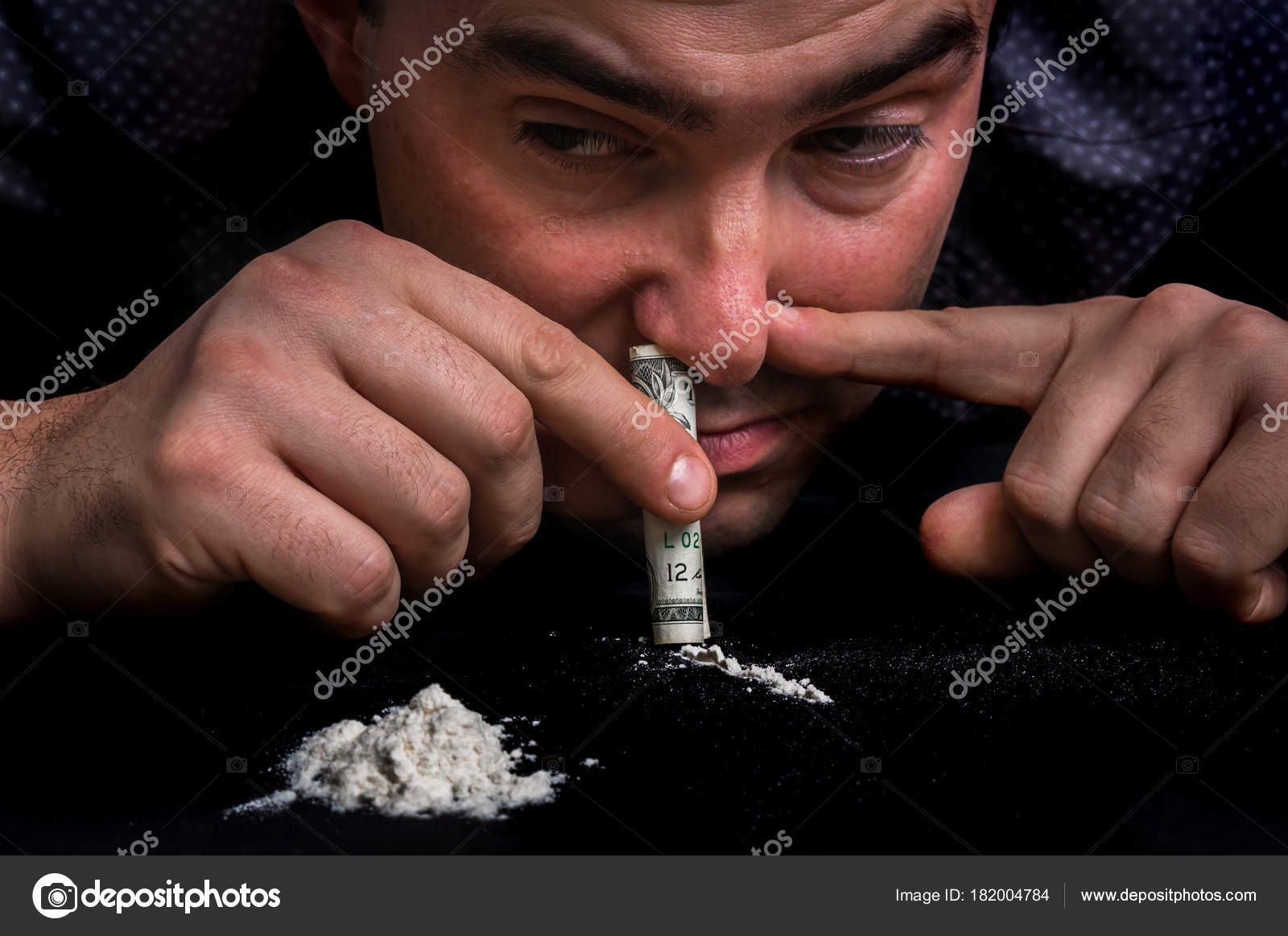 Junkie man snorting cocaine powder with rolled banknote — Stock Photo ...