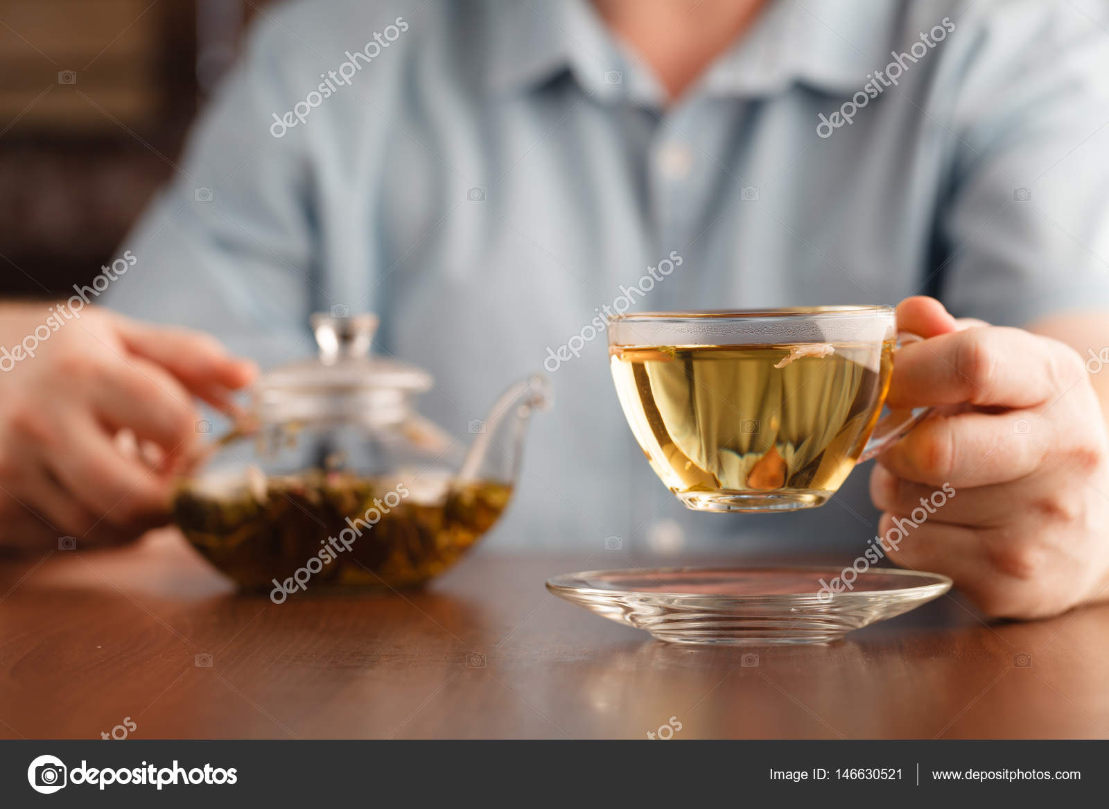 Man hold cup in hand and offer tea Stock Photo by ©AndreyCherkasov ...