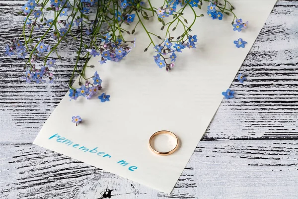 branch of forget-me-nots on paper with phrase remember me - Stock Image ...