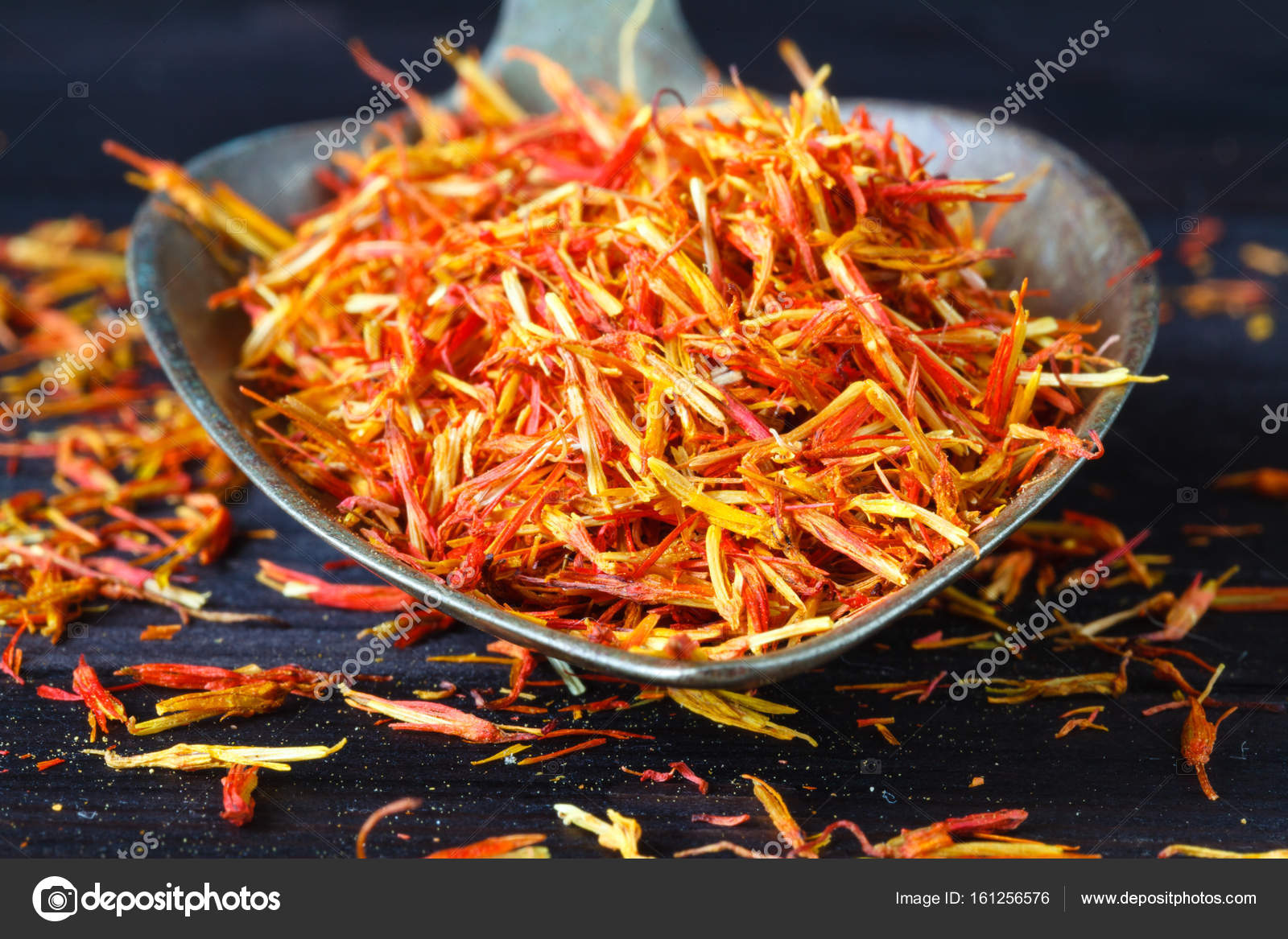 Shafran in vintage metal spoon on rustic table Stock Photo by ...