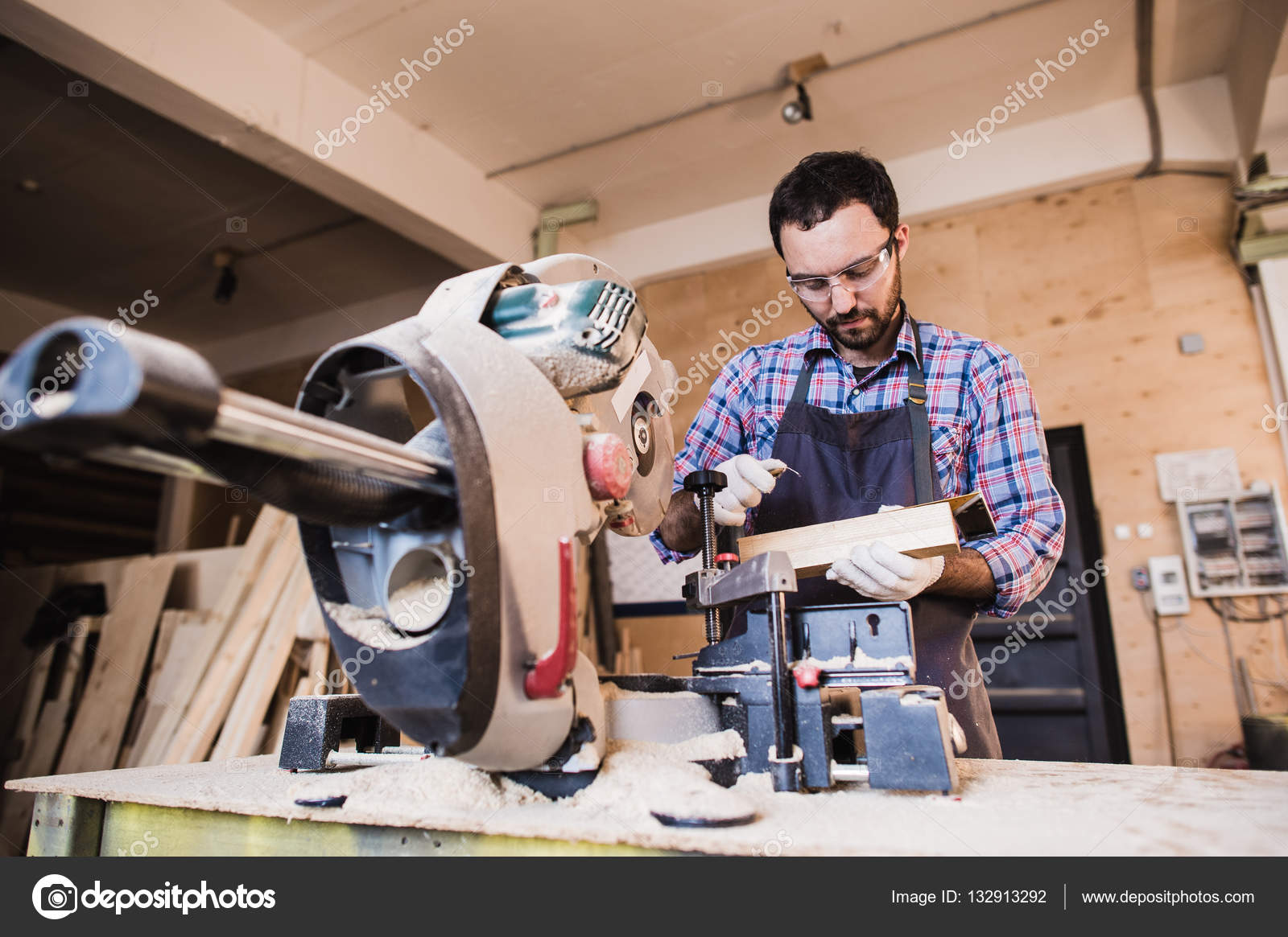 Framing contractor using a circular cut off saw to trim wood studs ...