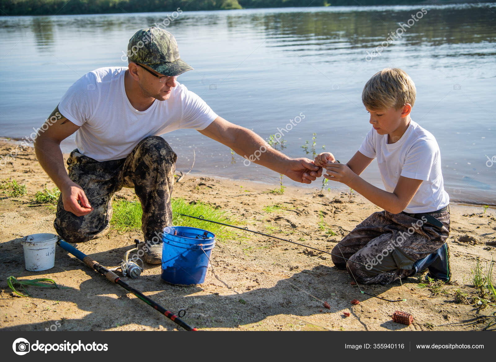 Teamwork. Father and son fishing on a summer weekend. Hobby and sport ...