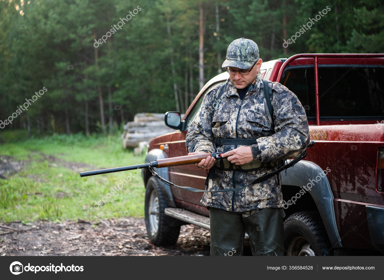Hunter male loading gun, wearing casual hunting clothes, stock and ...