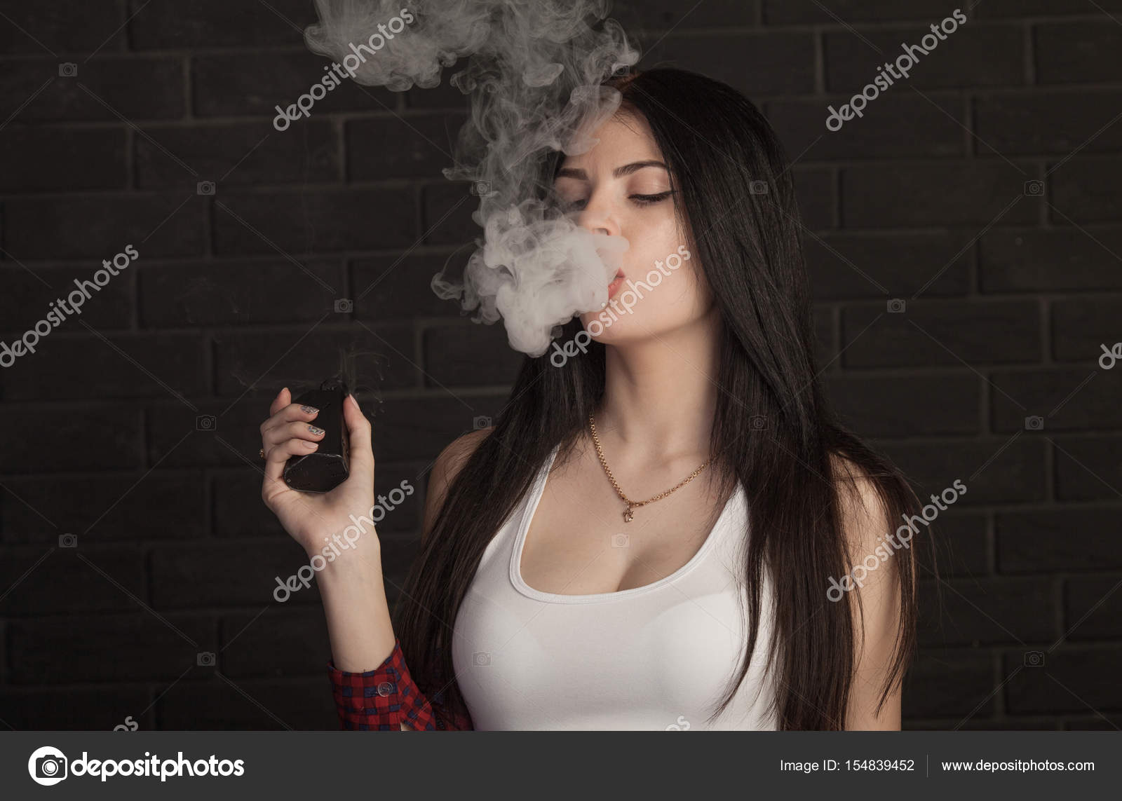 Young Beautiful Brunette Woman Smoking Vaping E Cigarette With Smoke On Black Background Stock