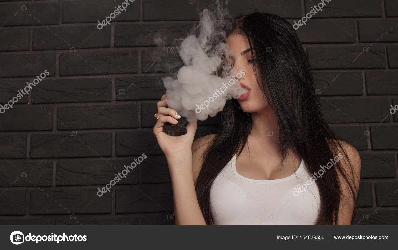 Young Beautiful Brunette Woman Smoking Vaping E Cigarette With Smoke