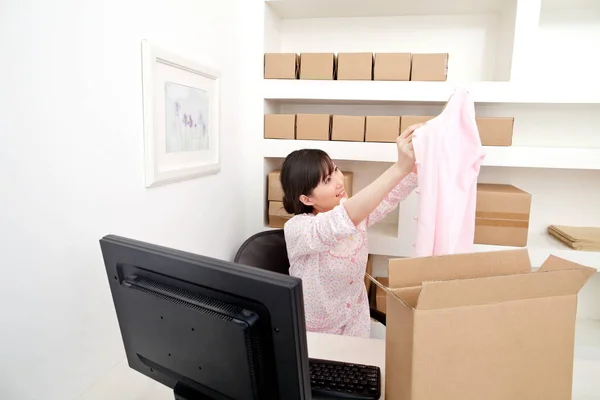 young woman with a toy box and a cardboard boxes - Stock Image - Everypixel