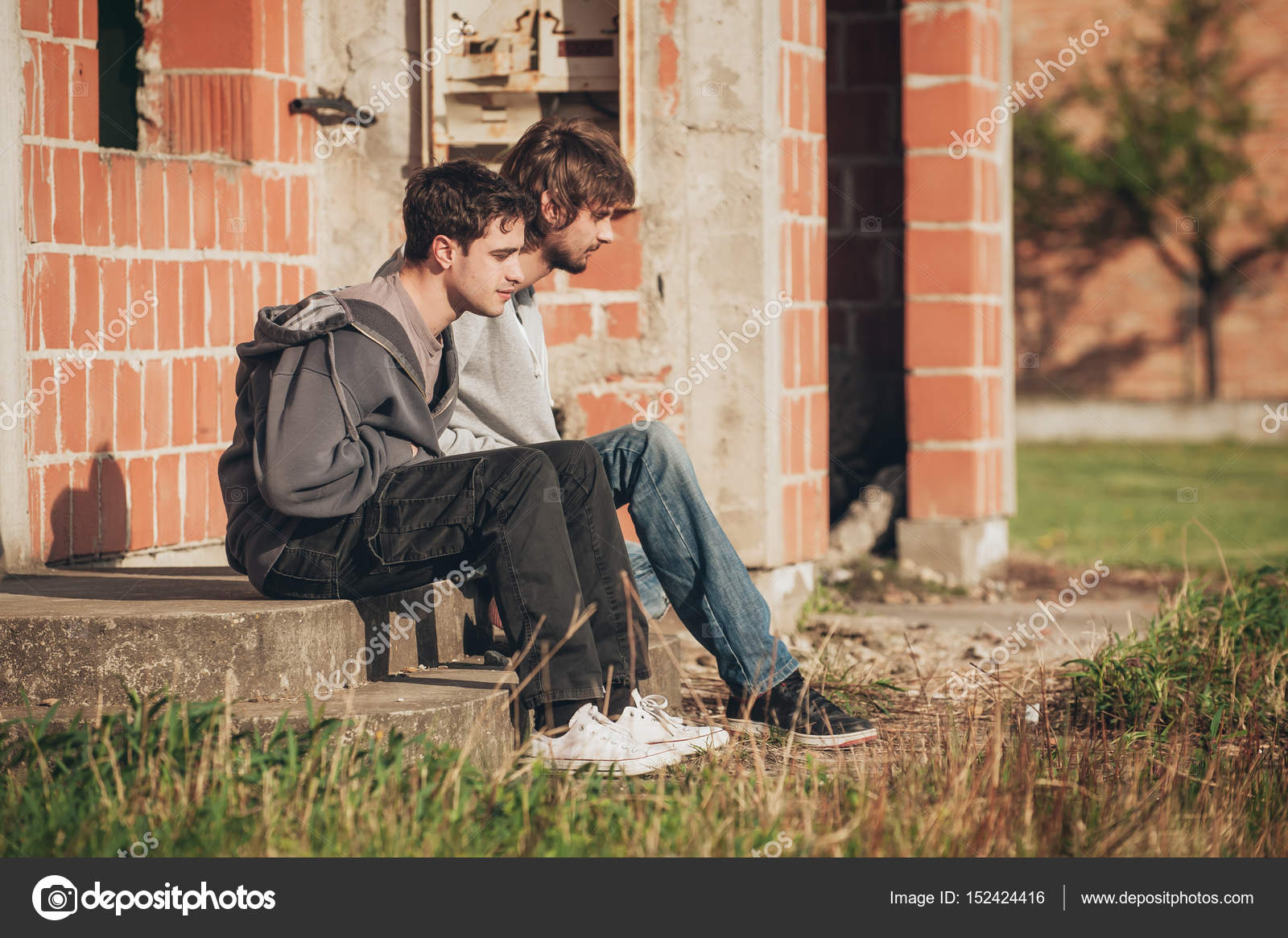 Two depressed and sad young buddies friends thinking about probl ...