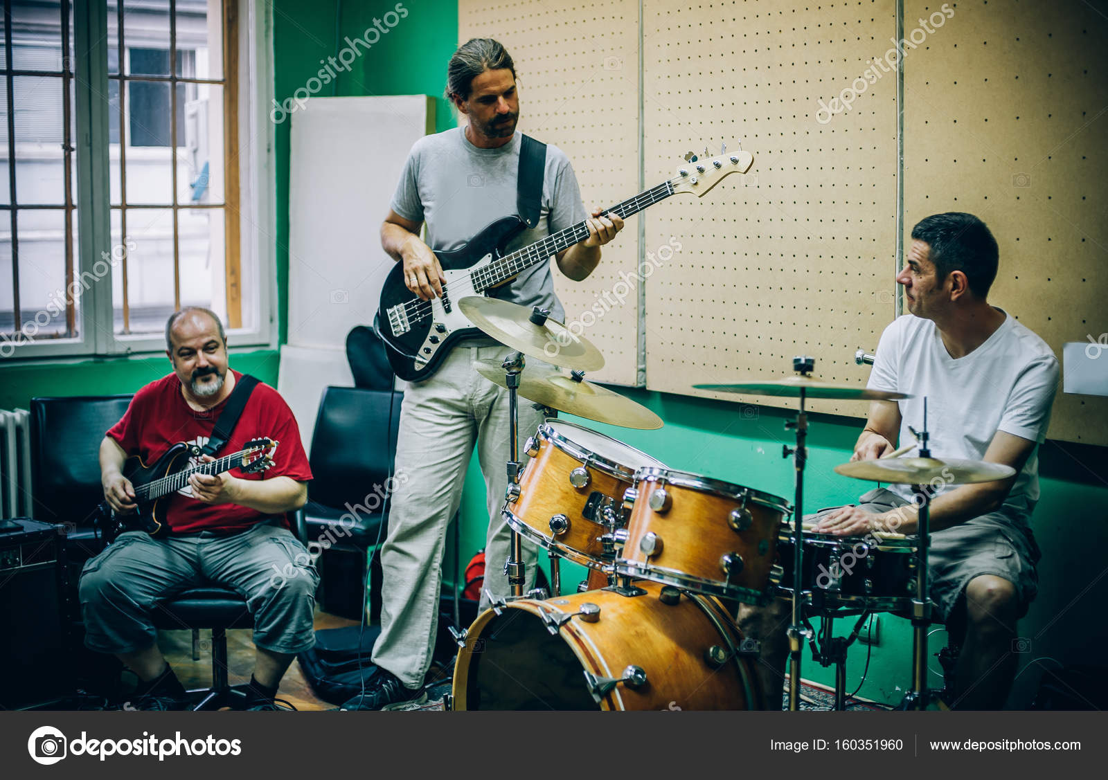Behind scene. Rock band practice in messy recording music studio Stock ...