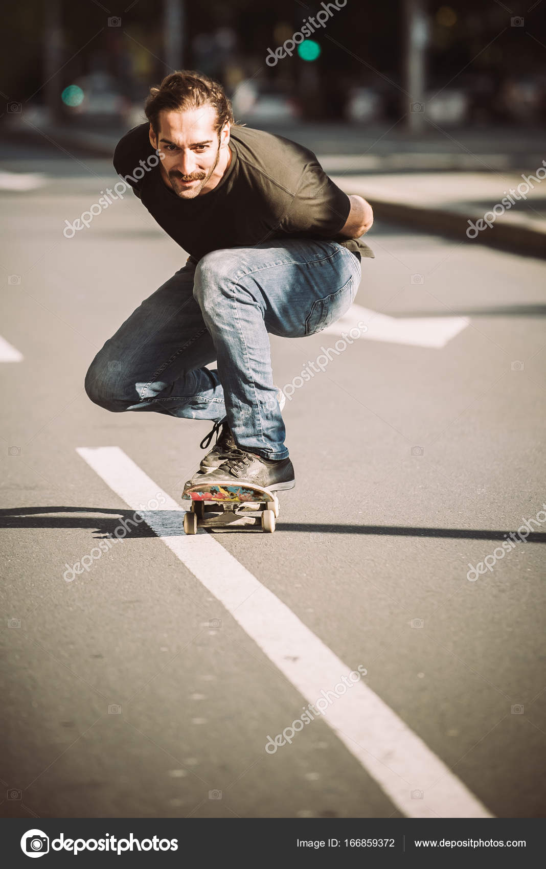 Skateboarder ride a skateboard slope through the city street Stock ...