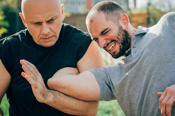 Street fight. One man fight with other. Street fighting - Stock Image ...