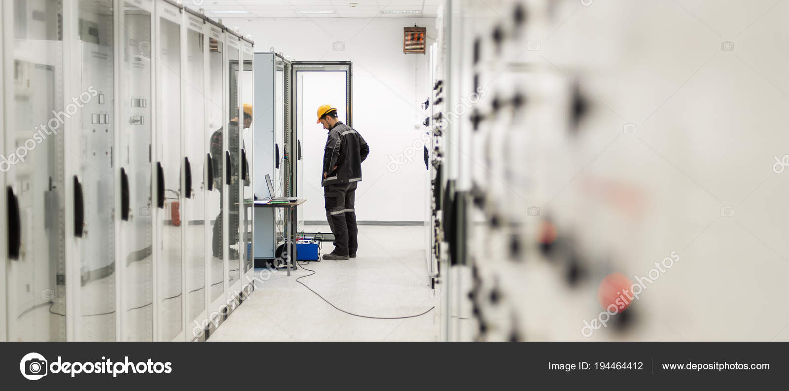 Engineer commissioning bay control unit. Engineering department Stock ...