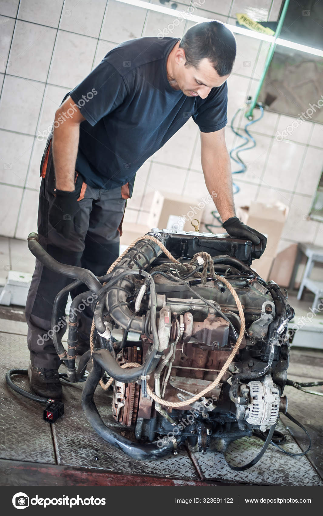 Removed engine from car. Auto mechanic repairs car engine Stock Photo ...