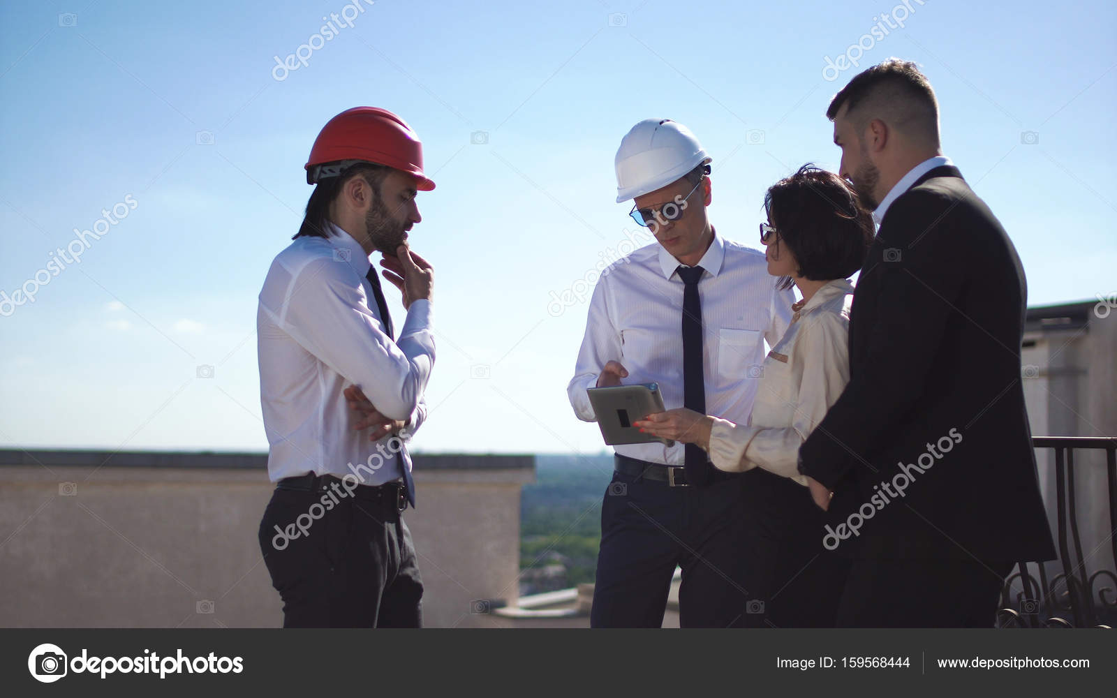Architects discussing project on rooftop Stock Photo by ...