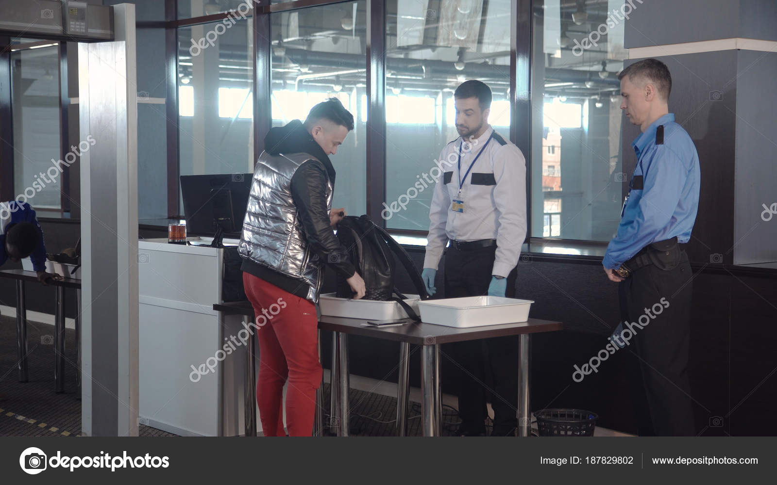 Guard checking passenger bag in airport Stock Photo by ...