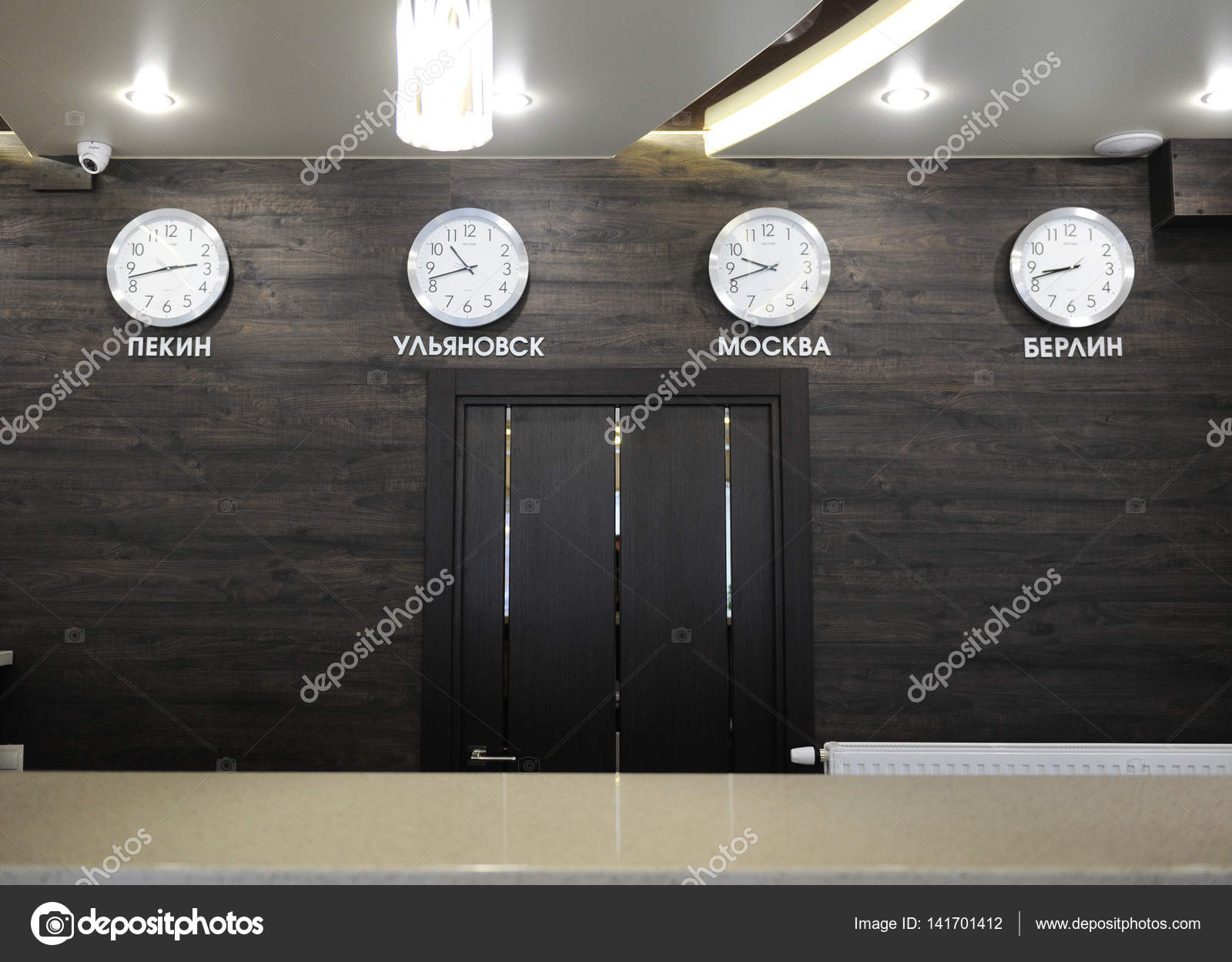 Wall clocks with different time zones. At the reception at the hotel ...
