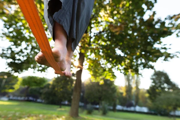 Man practising slack line in park - Stock Image - Everypixel