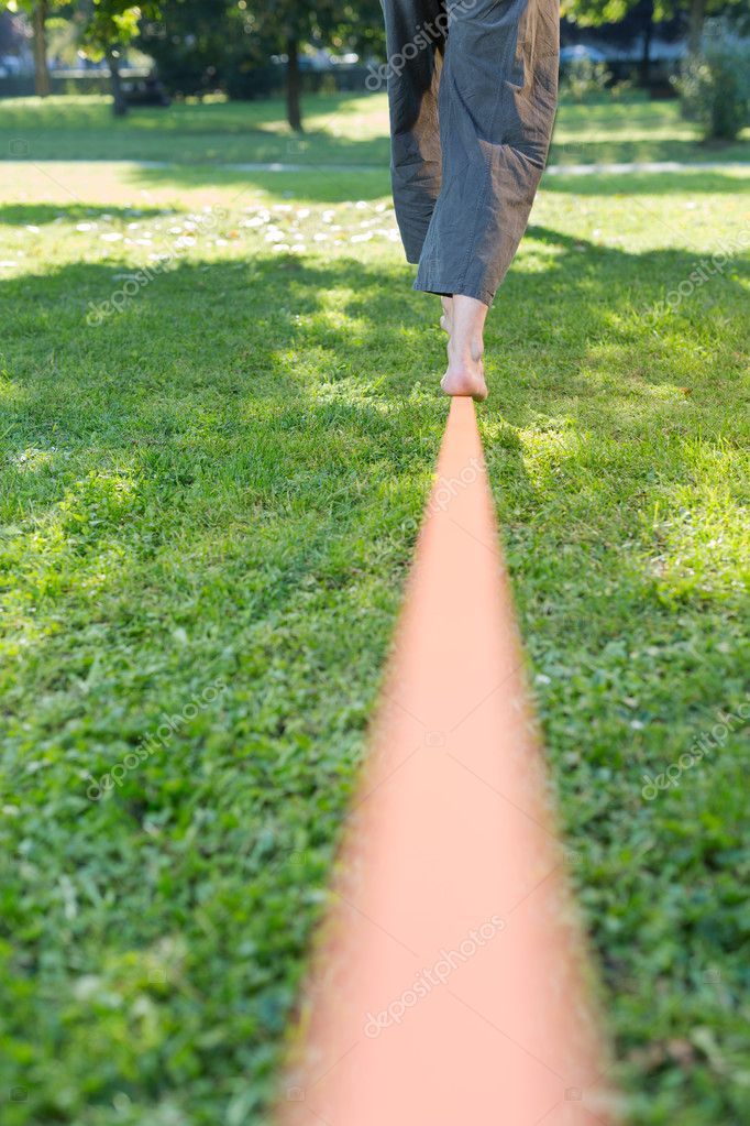 Man practising slack line in park — Stock Photo © Myvisuals #127649024