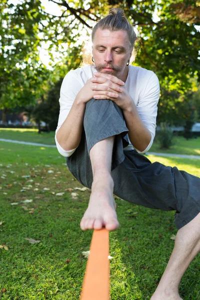 Man practising slack line in park — Stock Photo © Myvisuals #127649024
