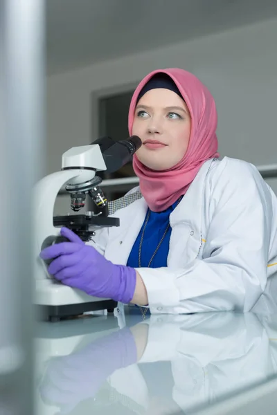 Female Muslim Scientist Looking Microscope Experiment Colleague Working ...