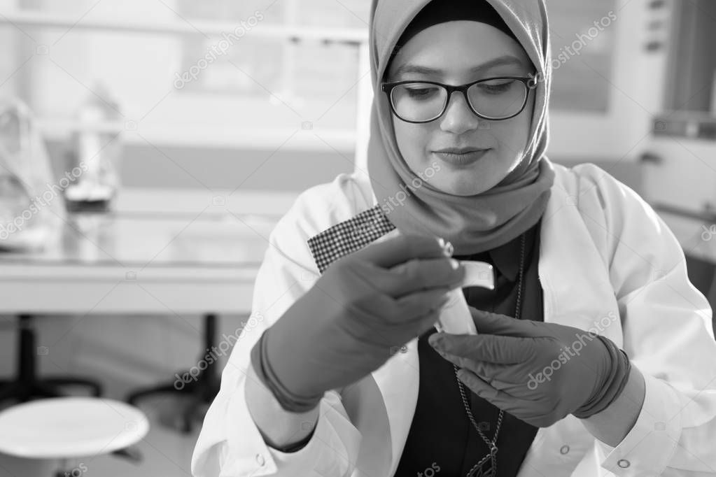 Muslim lab worker with hijab Stock Photo by ©Myvisuals 130044018