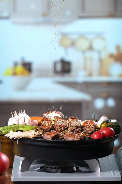 cooking meat with vegetables and spices on kitchen table - Stock Image ...