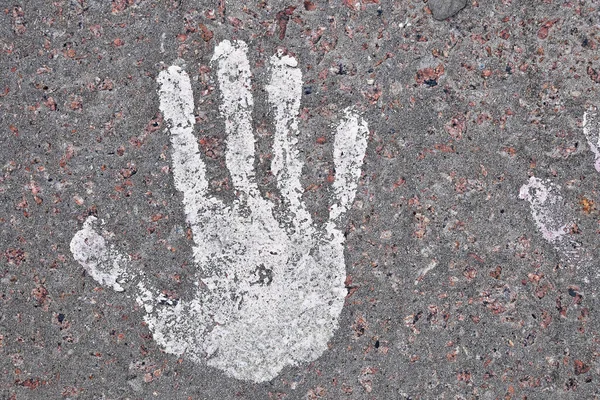 Close up human hand or palm shaped paint print on grunge concrete ...