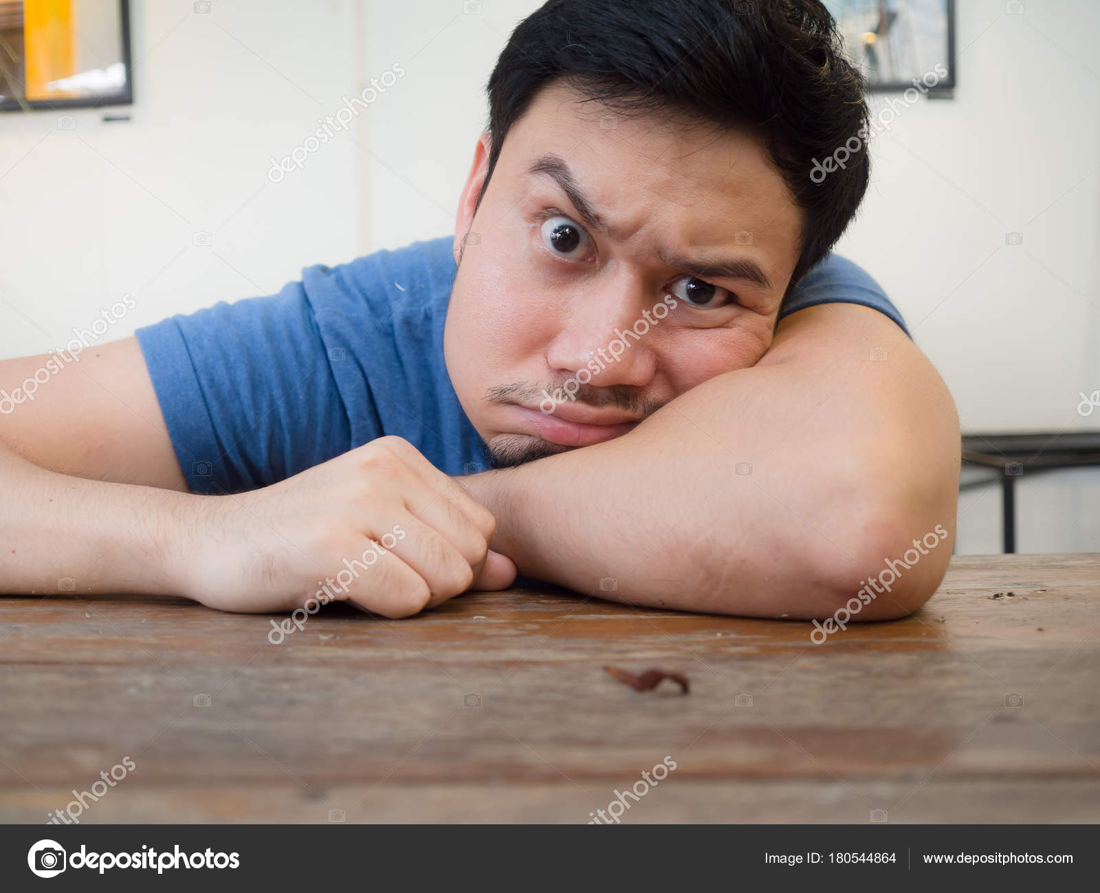 Boring and serious face man rest his chin on his hand. Stock Photo by ...