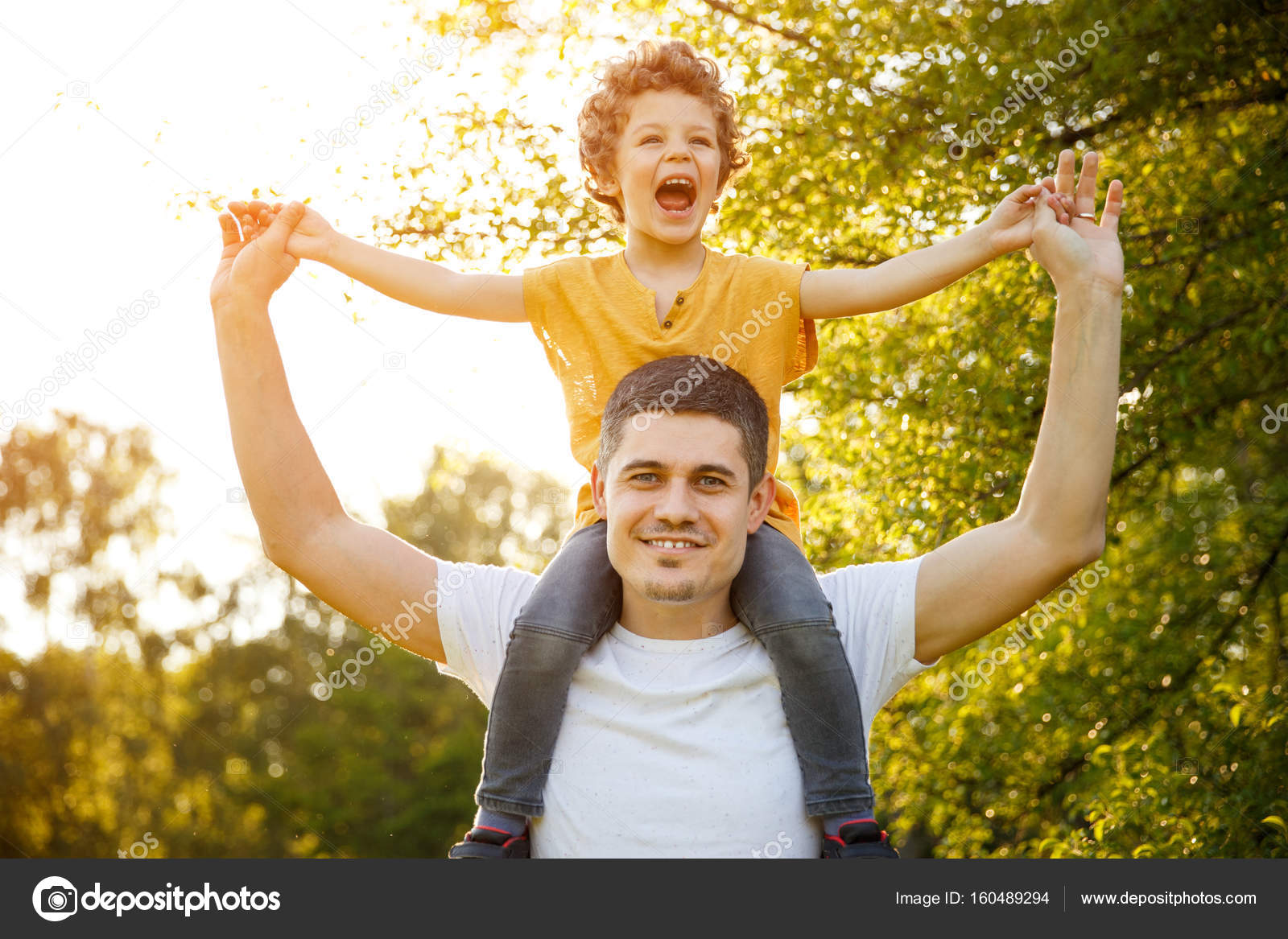 Child riding on father shoulders in forest — Stock Photo © kegfire ...