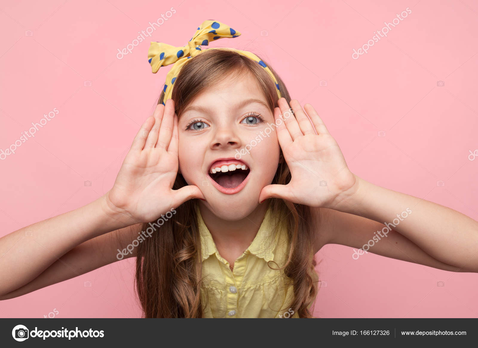Little girl shouting at camera on pink Stock Photo by ©kegfire 166127326