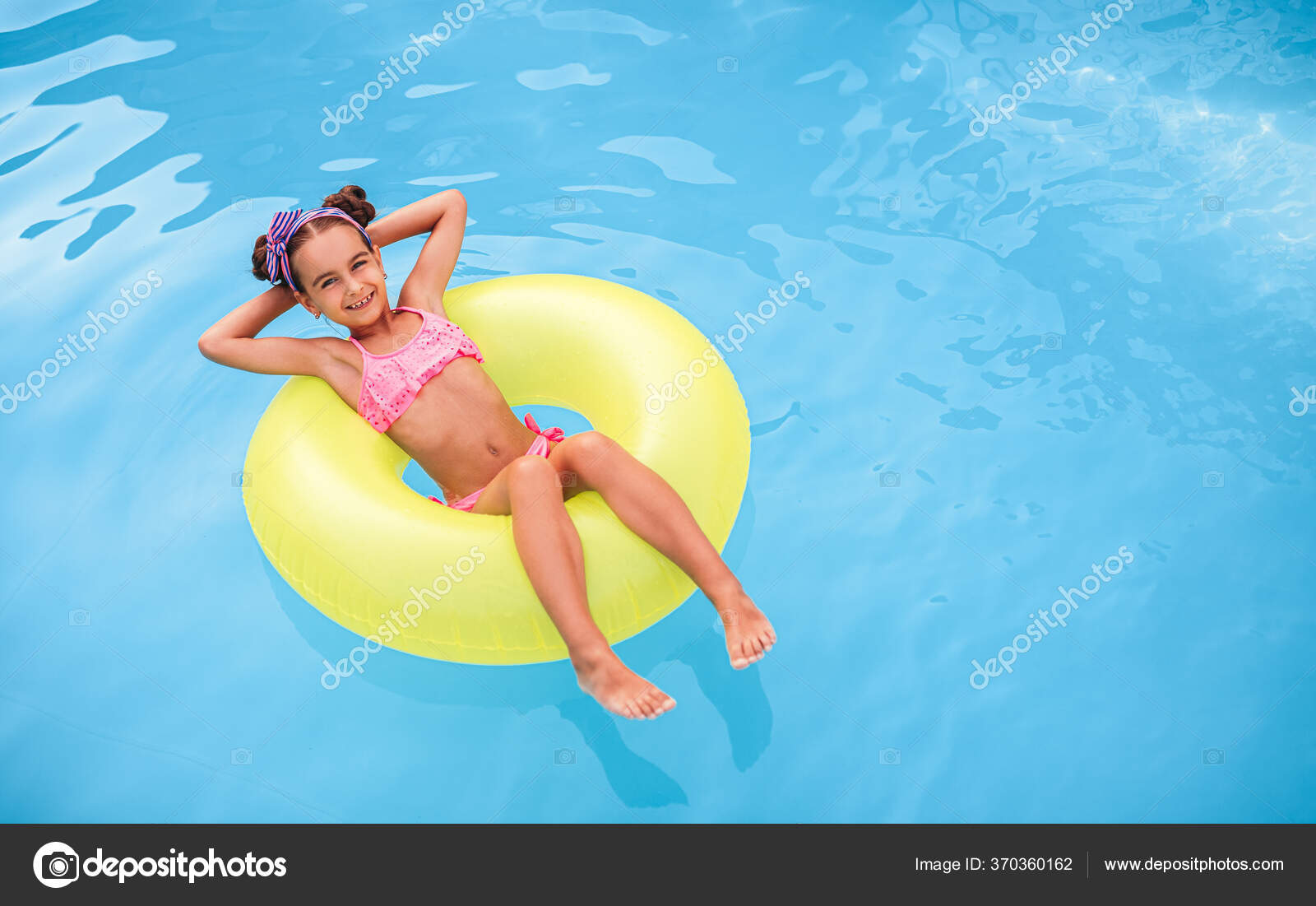 Happy girl floating on pool water — Stock Photo © kegfire #370360162