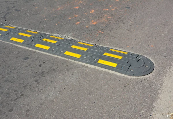 Traffic safety speed bump with crosswalk on an asphalt road. Speed ...