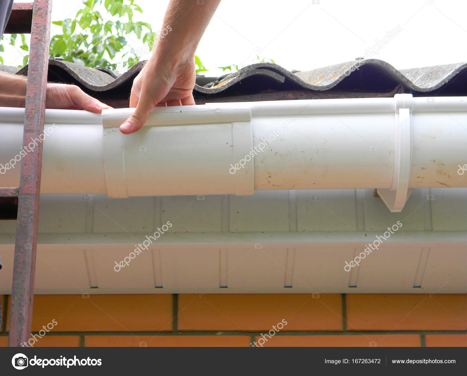 Contractor Installing rain gutter system on the roof. Stock Photo by ...