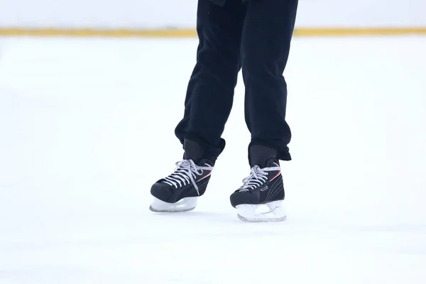 the legs of a man skating on an ice rink - Stock Image - Everypixel