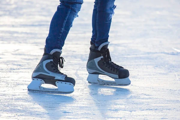 Legs of a man skating on an ice rink. Hobbies and sports. Vacations and ...