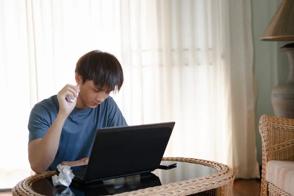 Handsome man looking computer screen and hand holding crumpling paper ...