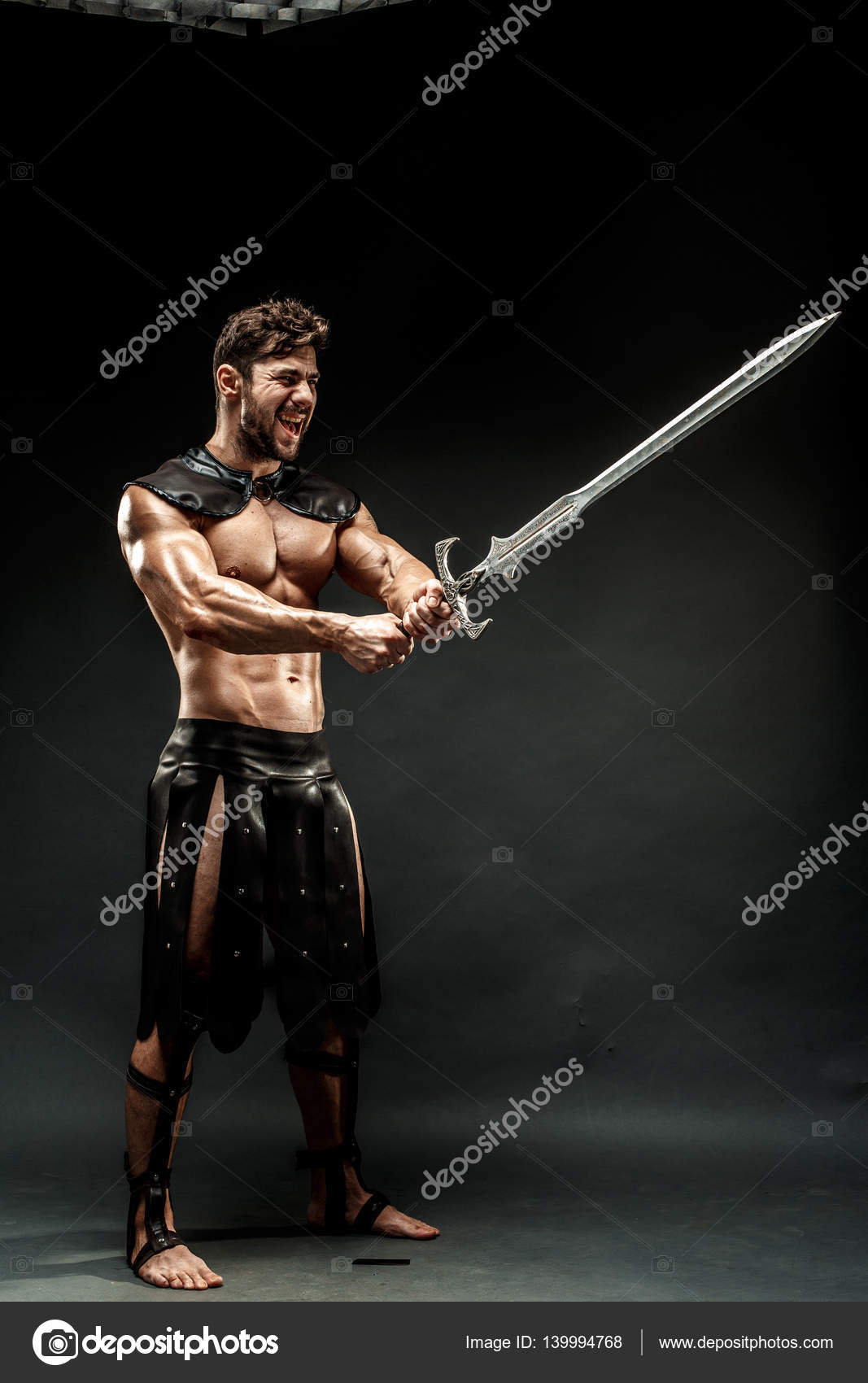 Severe barbarian in leather costume with sword — Stock Photo © zamuruev #139994768