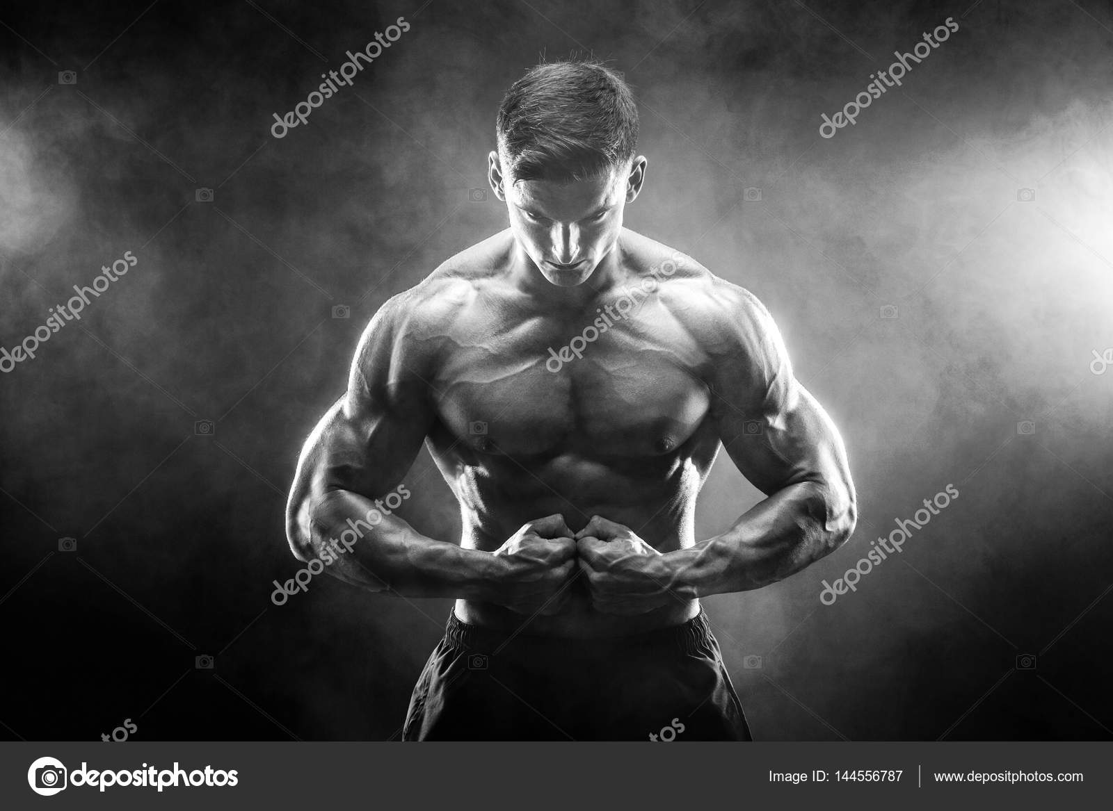 Strong bodybuilder man with perfect body- abs, shoulders, biceps ...