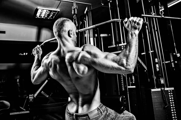 Strong Bodybuilder Doing Heavy Weight Exercise For Back On Machine ...