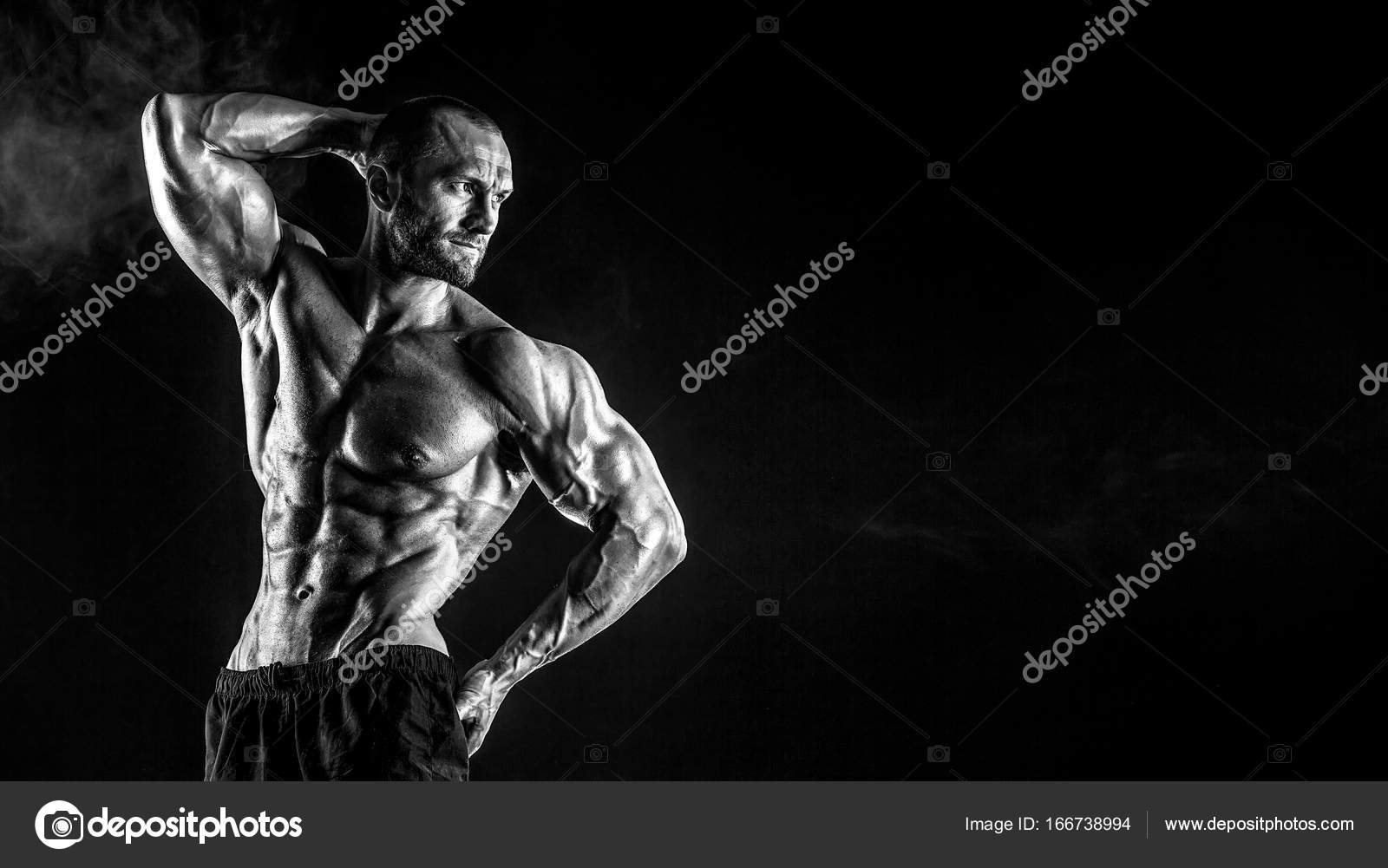 Strong bodybuilder man with perfect abs, shoulders,biceps, triceps ...