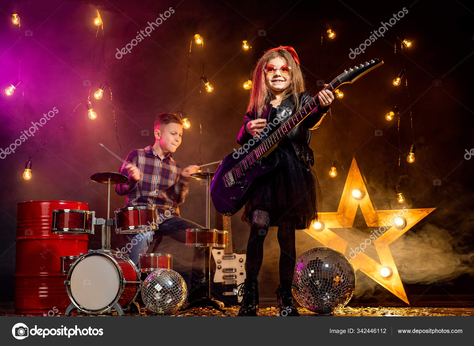 Kids pretending to be in a rock band Stock Photo by ©zamuruev 342446112