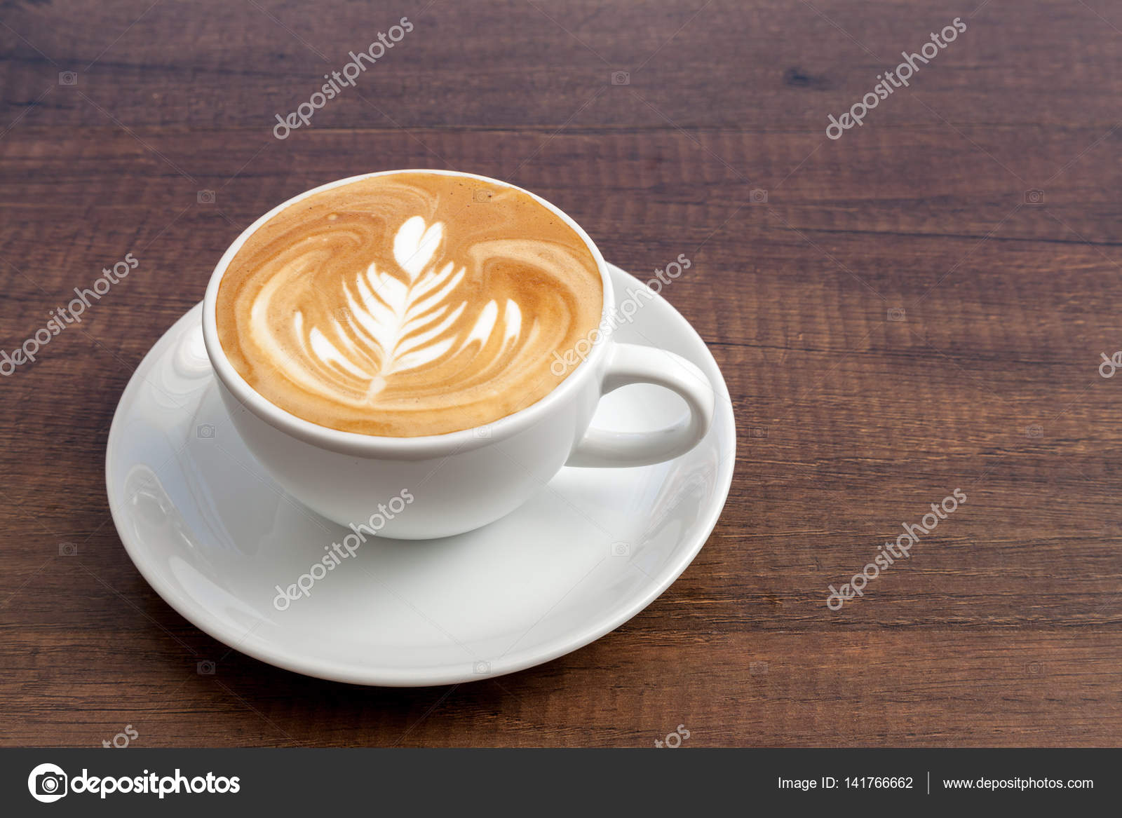 Coffee cup of rosetta latte art on wooden background with copy space ...