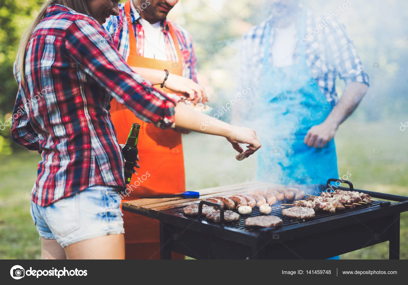 Happy people enjoying bbq Stock Photo by ©nd3000 141459748